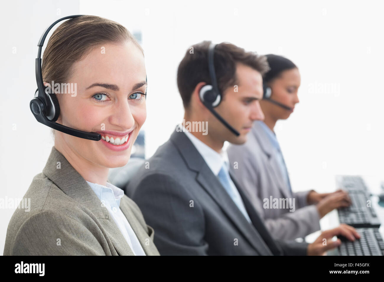Business people with headsets using computers Stock Photo - Alamy