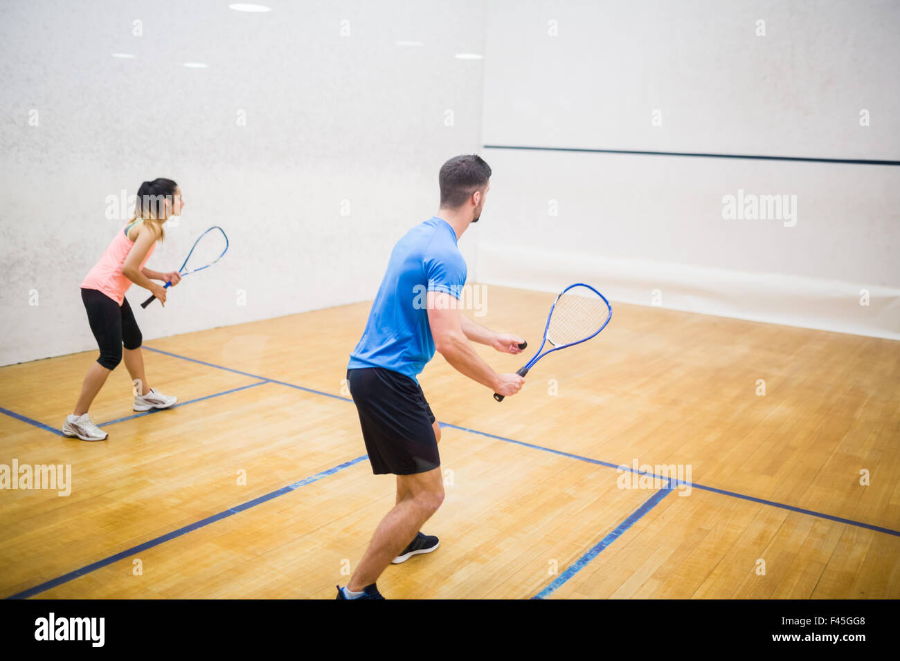 Couple enjoying a game of squash Stock Photo - Alamy