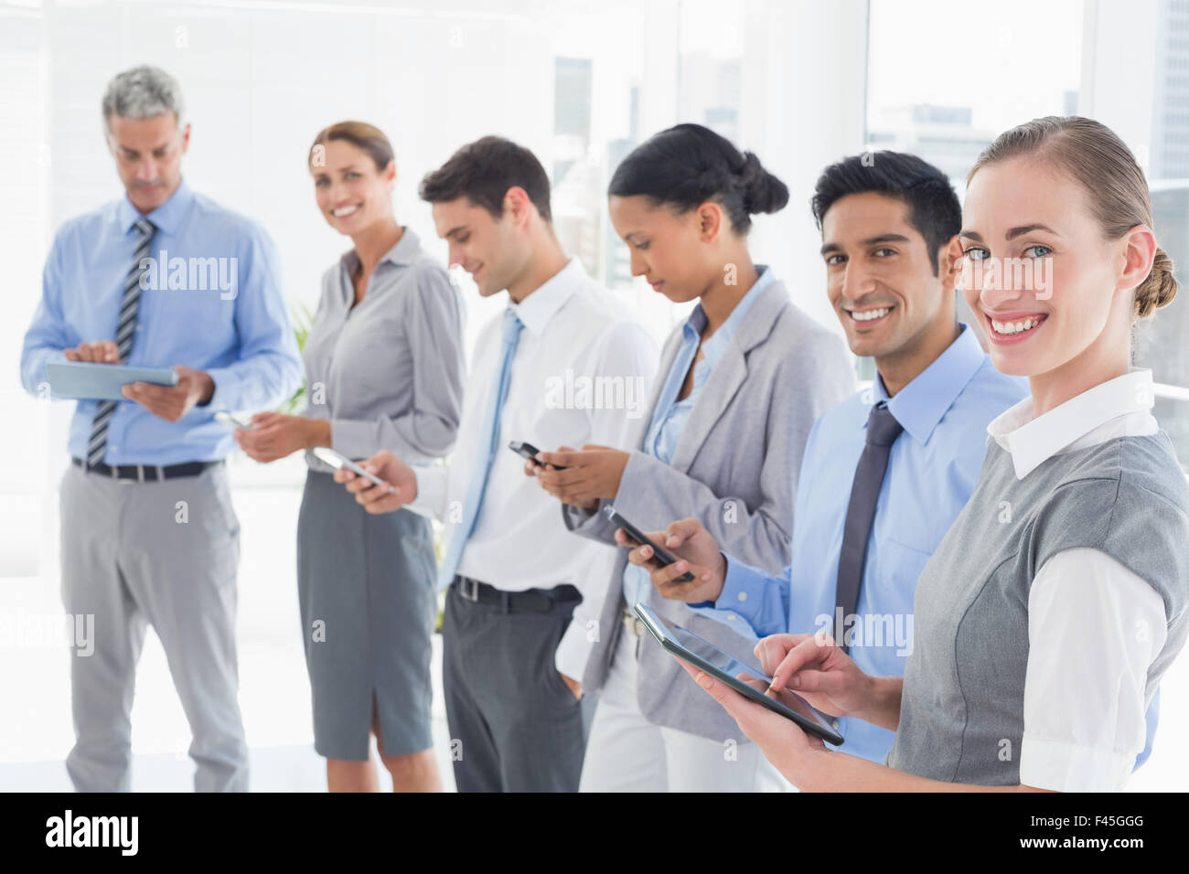 Business people using their phone Stock Photo - Alamy