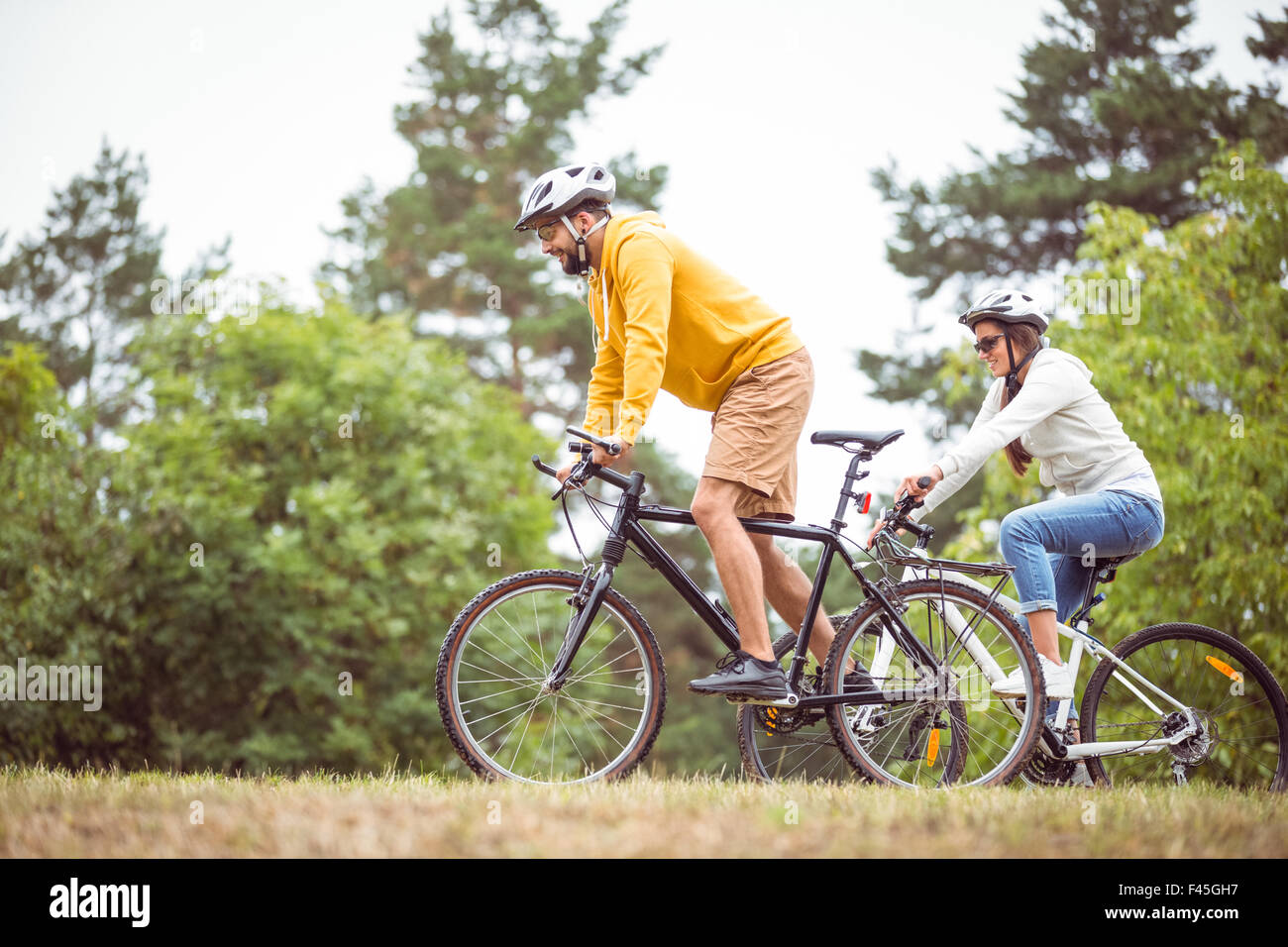 Happy couple on a bike ride Stock Photo - Alamy