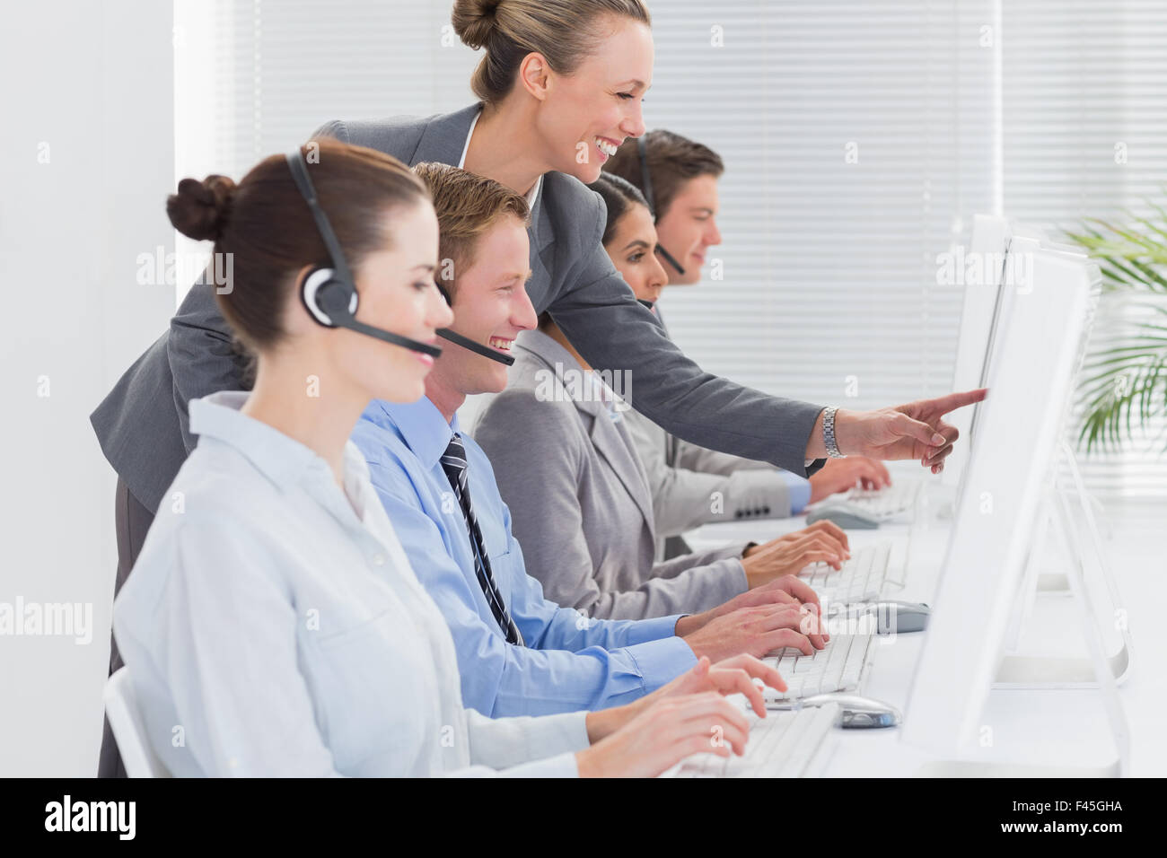 Manager checking the work of the staff Stock Photo - Alamy