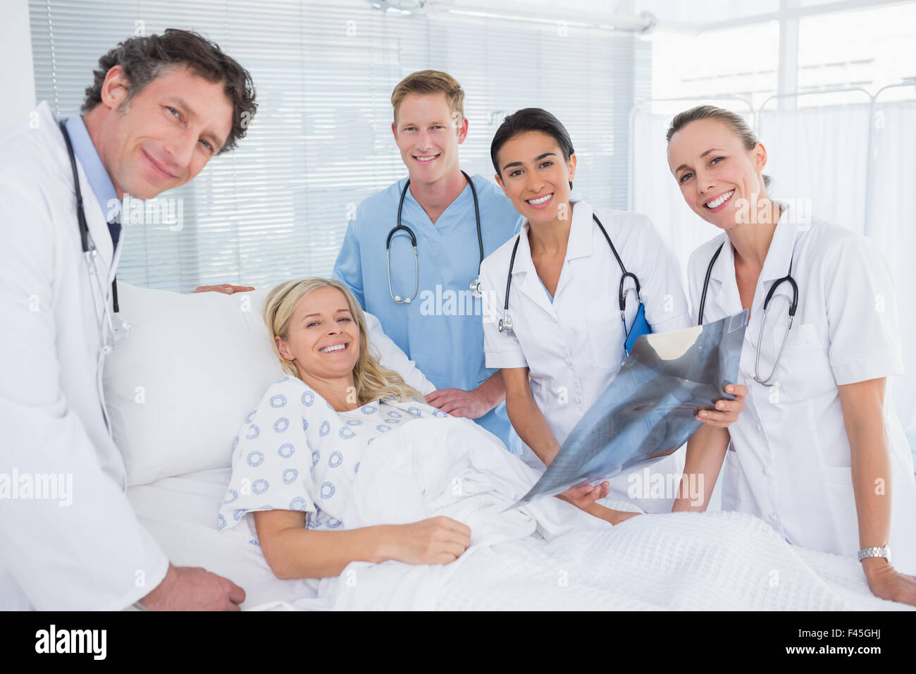 Smiling doctors showing xray to patient Stock Photo - Alamy