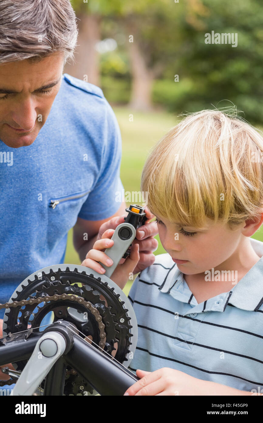 Father and his son fixing a bike Stock Photo - Alamy