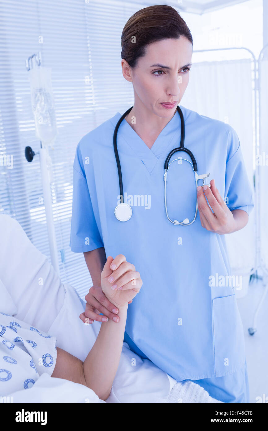 Concentrated doctor checking patients hi-res stock photography and ...