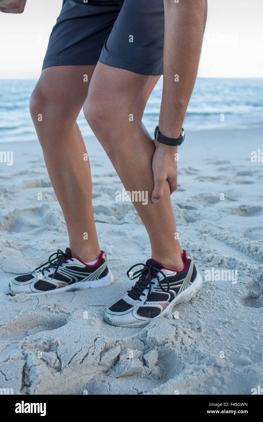 Fit man having muscle pain Stock Photo - Alamy