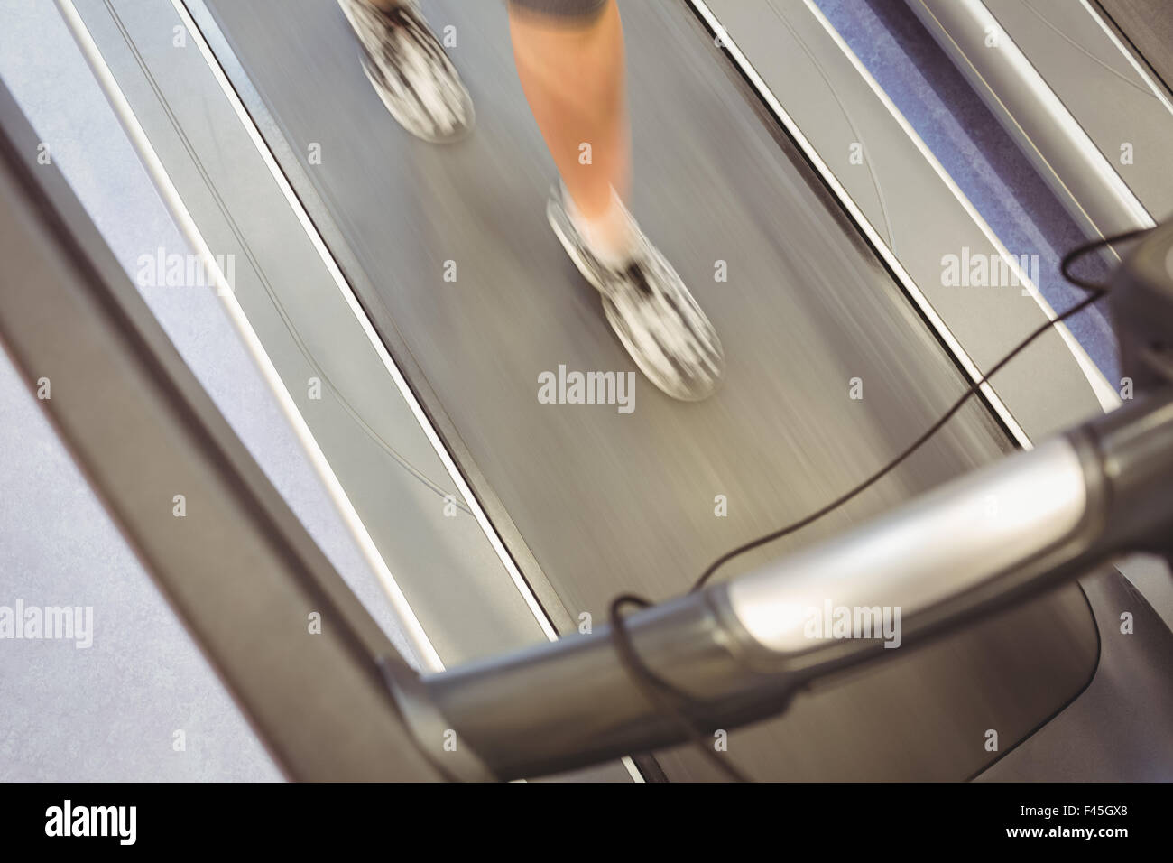 Fit woman jogging on treadmill Stock Photo - Alamy