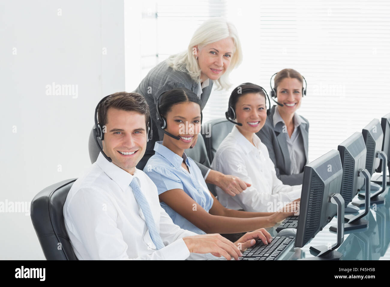 Businesswoman with executives using computers Stock Photo - Alamy