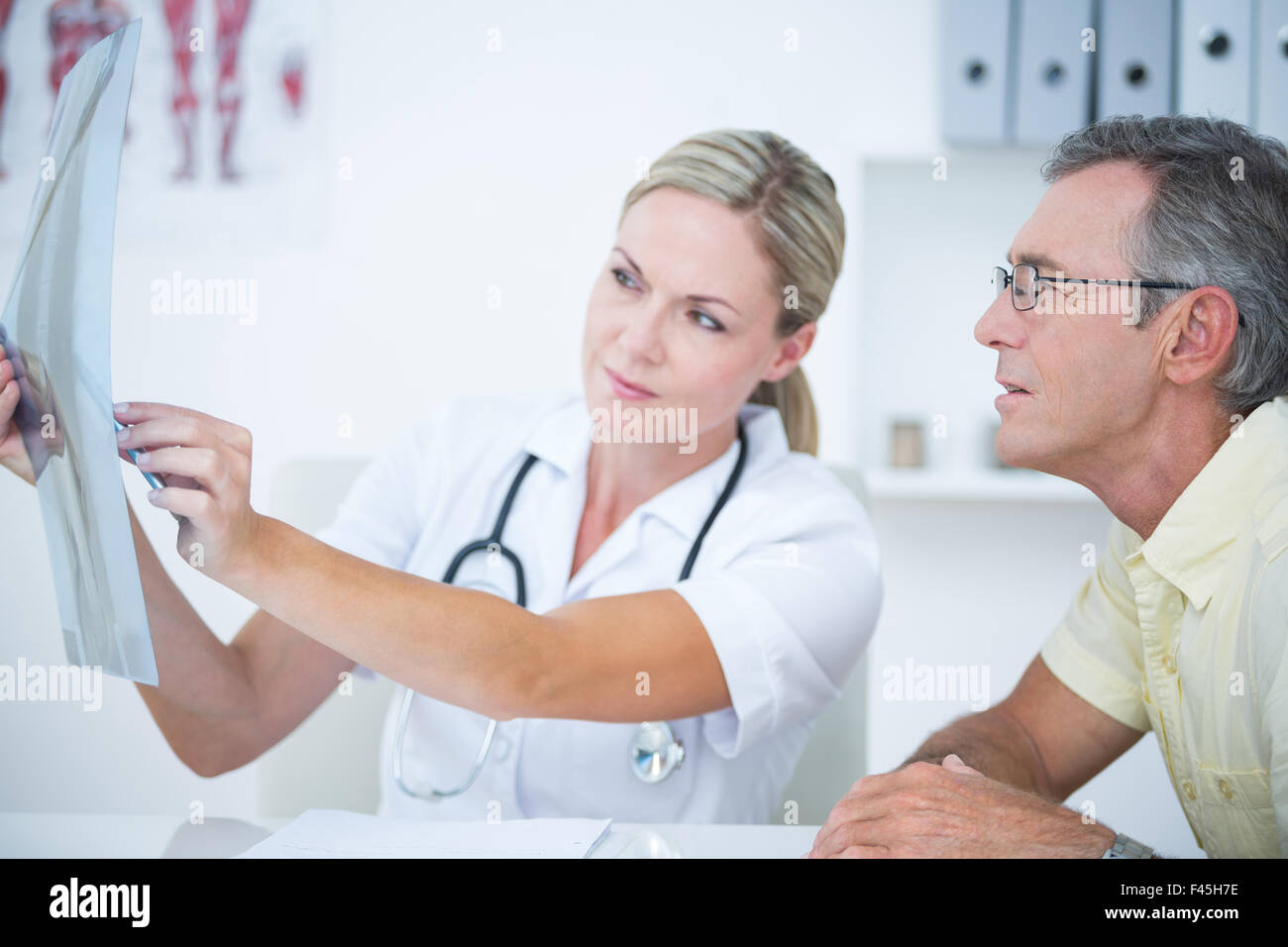Doctor showing X rays to her patient Stock Photo - Alamy