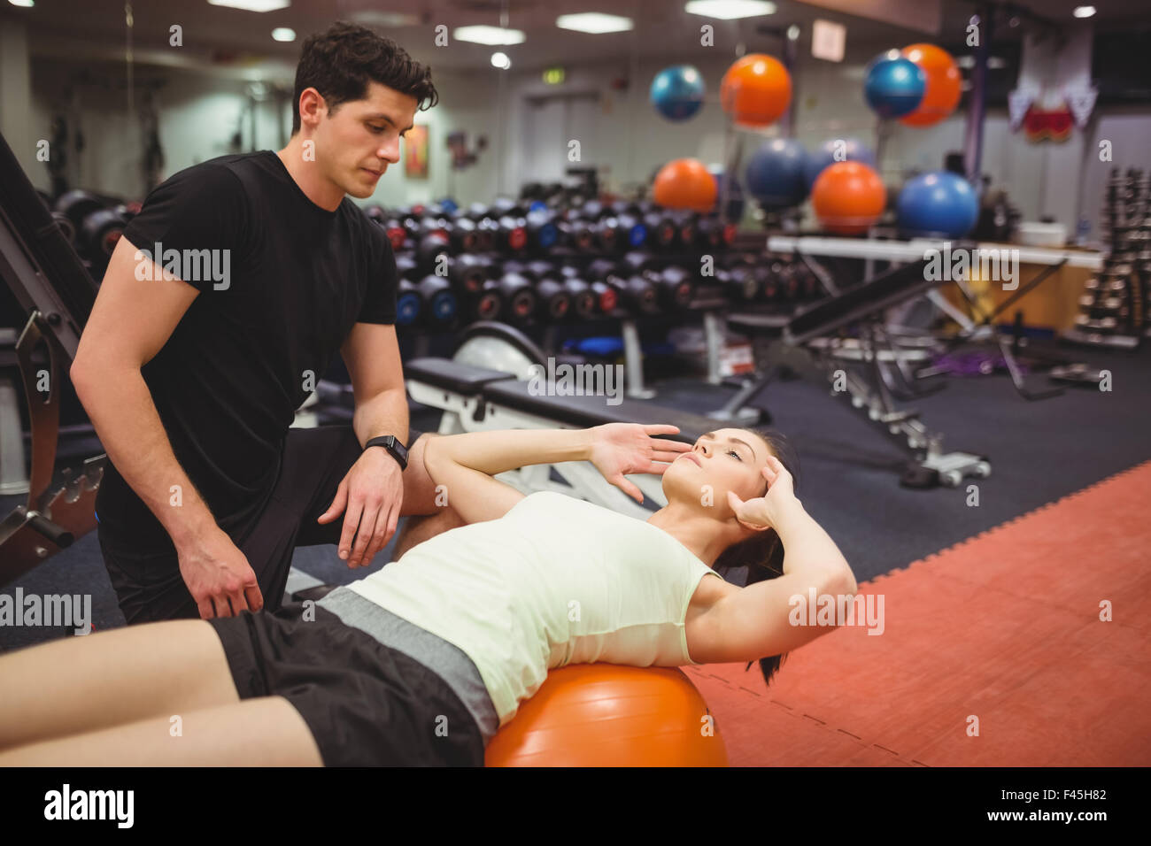 Fit woman working out with trainer Stock Photo - Alamy