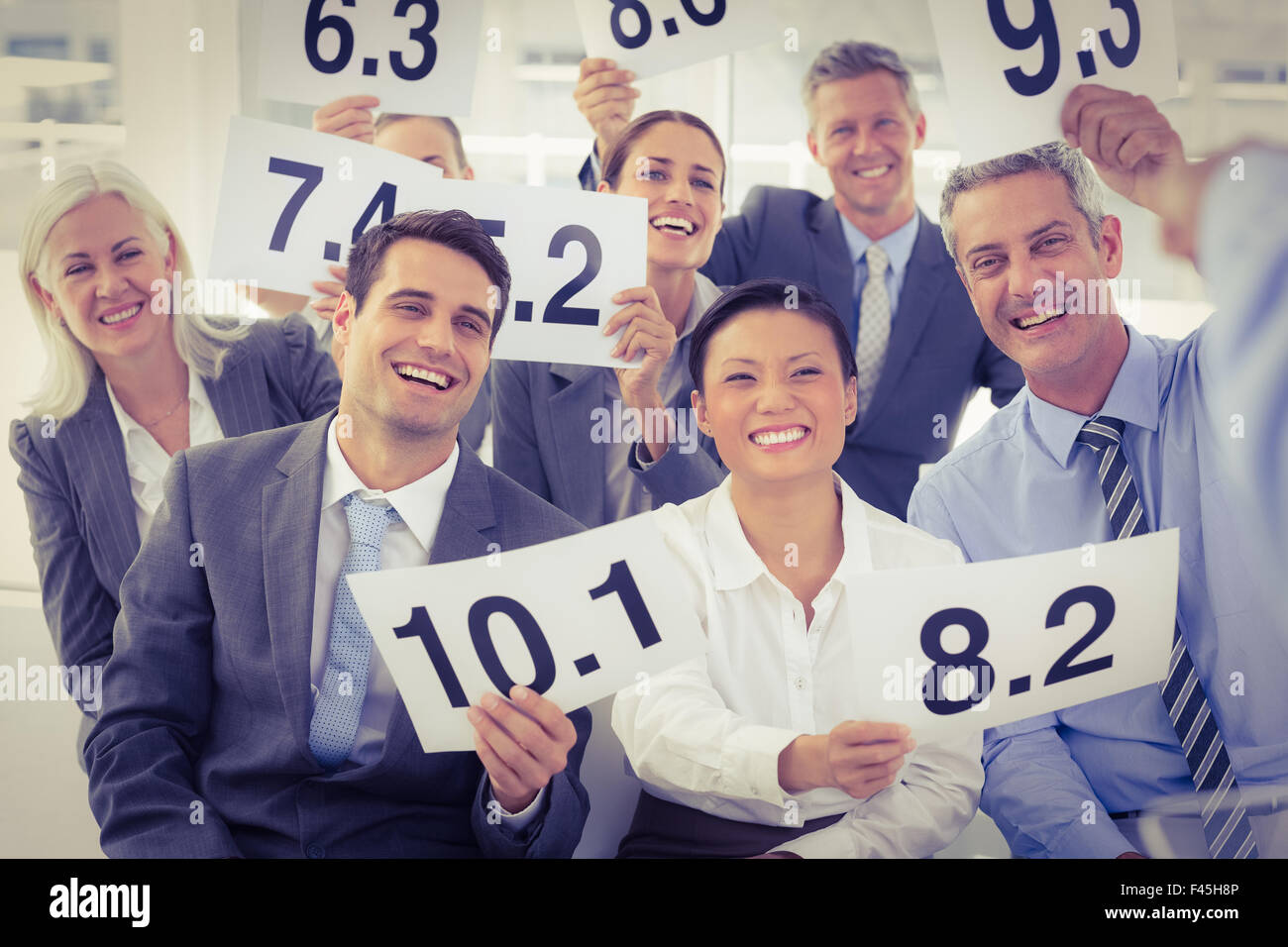 Interview panel holding score cards Stock Photo - Alamy
