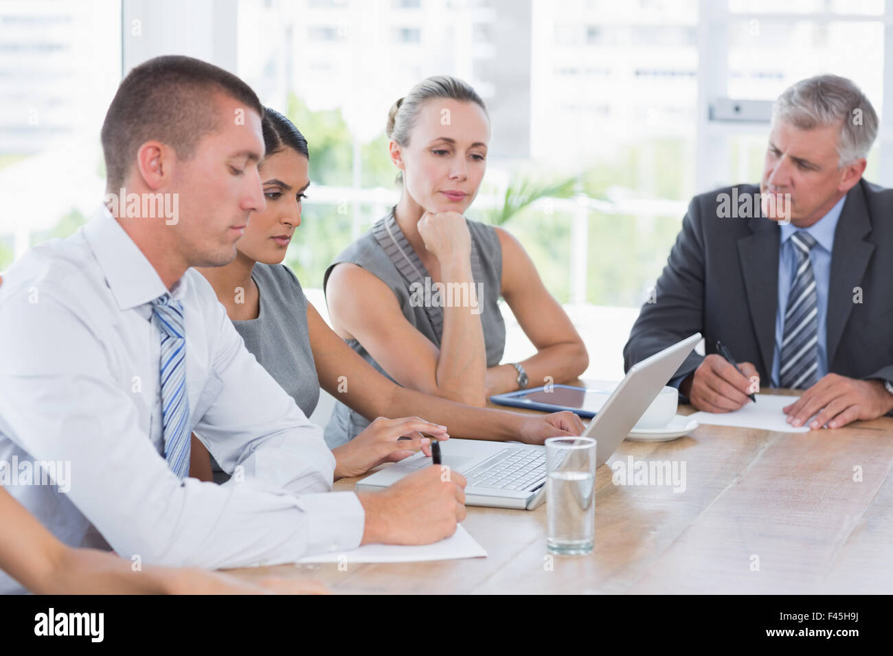 Concentrated business team during meeting Stock Photo - Alamy