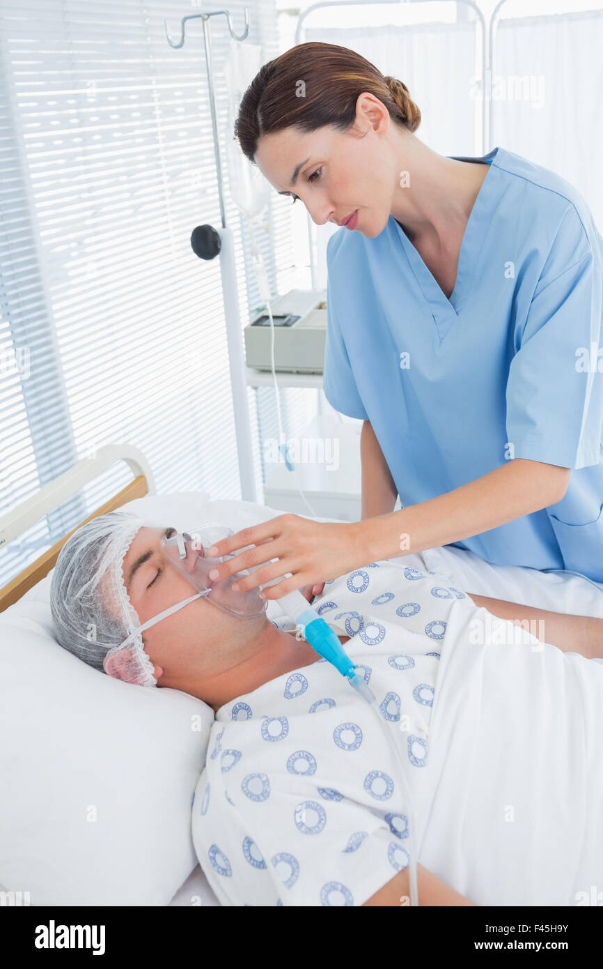 Doctor holding patients oxygen mask Stock Photo - Alamy