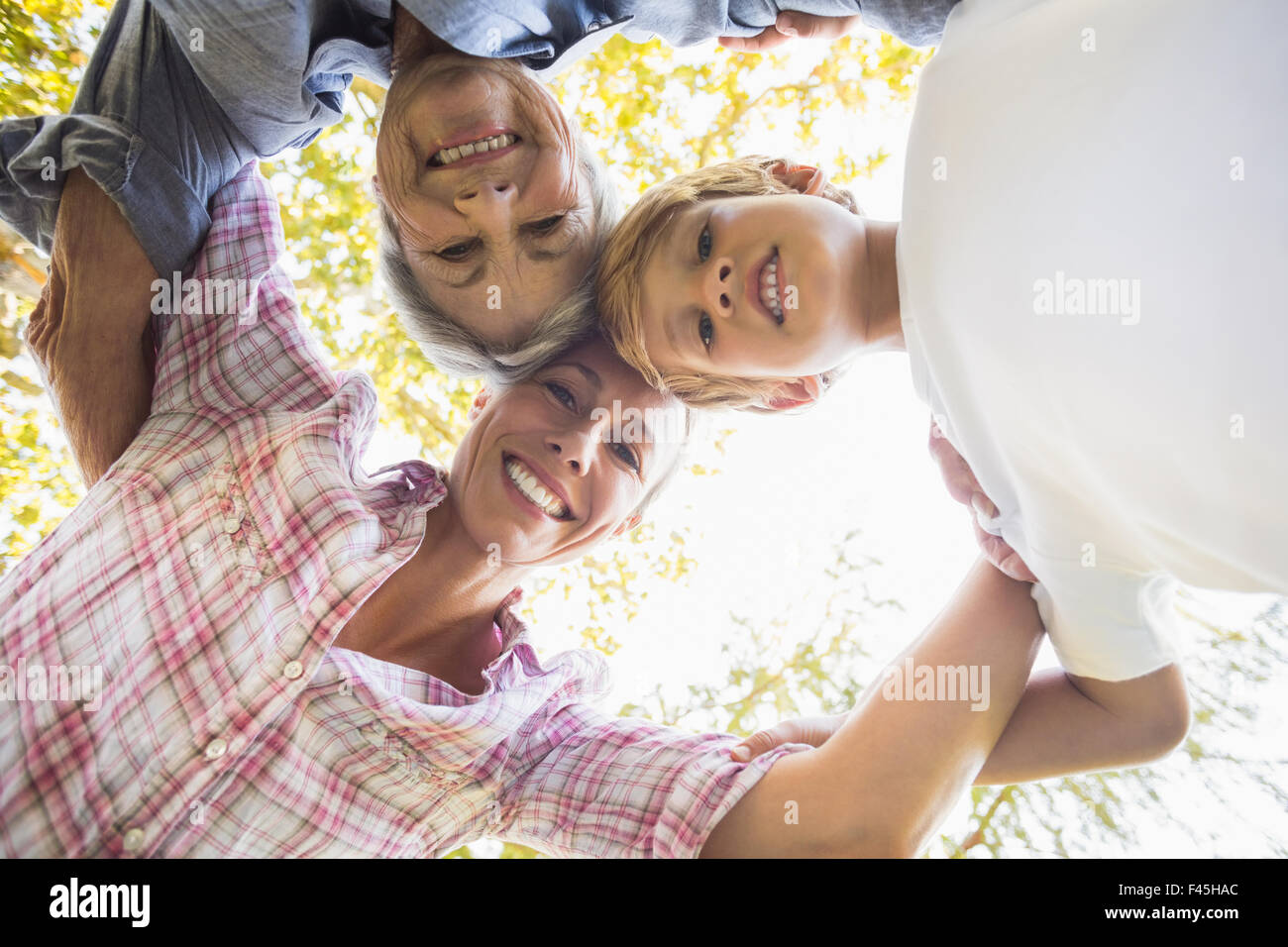 Happy family looking down the camera Stock Photo - Alamy