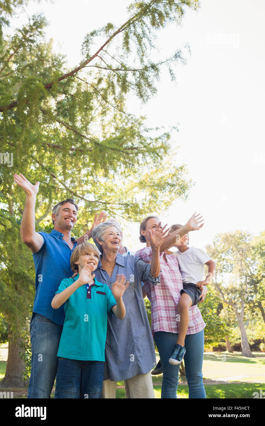 Happy family waving hands in the park Stock Photo - Alamy
