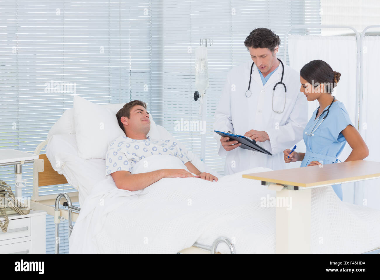 Doctors taking care of patient Stock Photo - Alamy