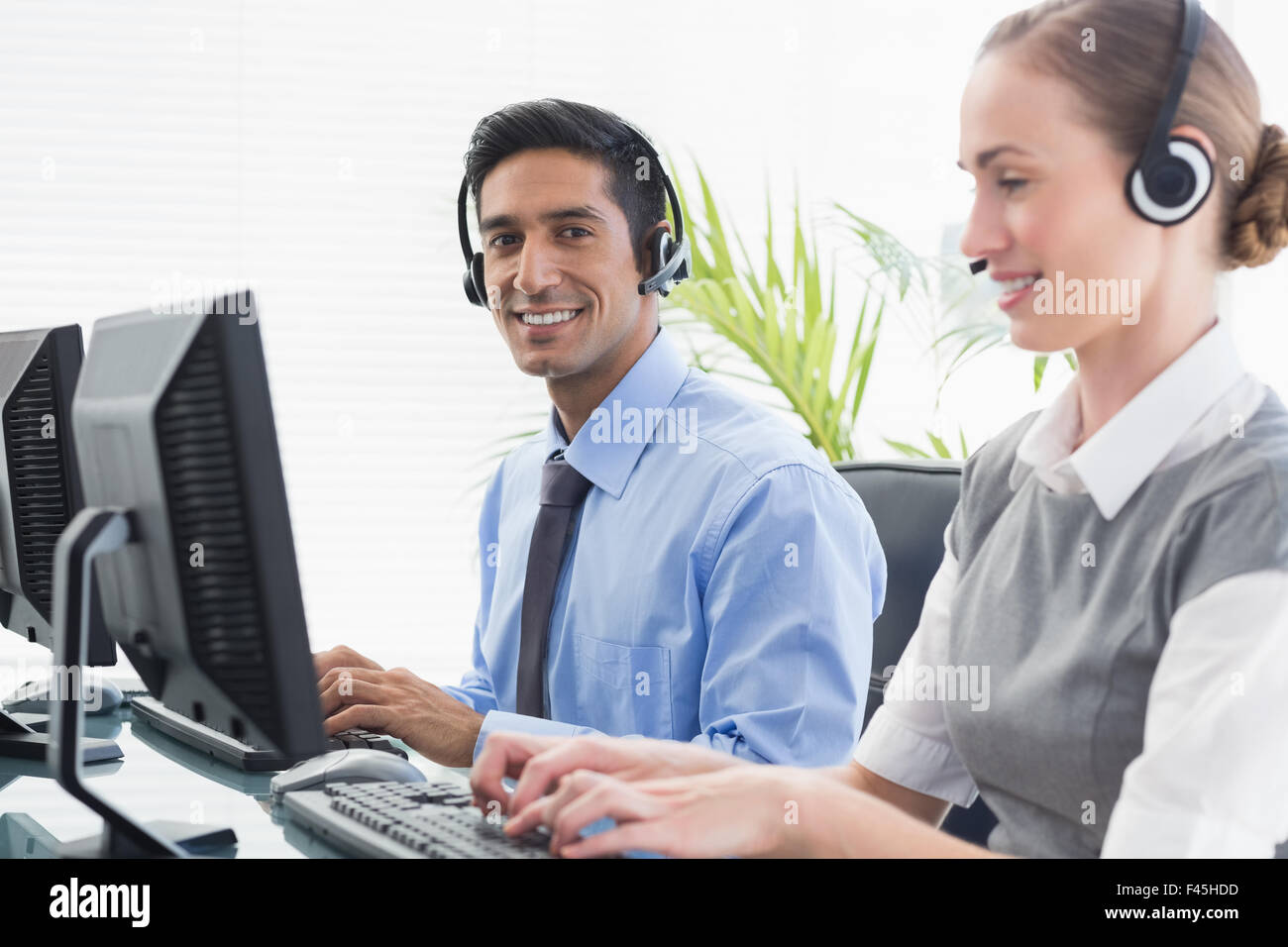 Business people headsets using computers hi-res stock photography and ...