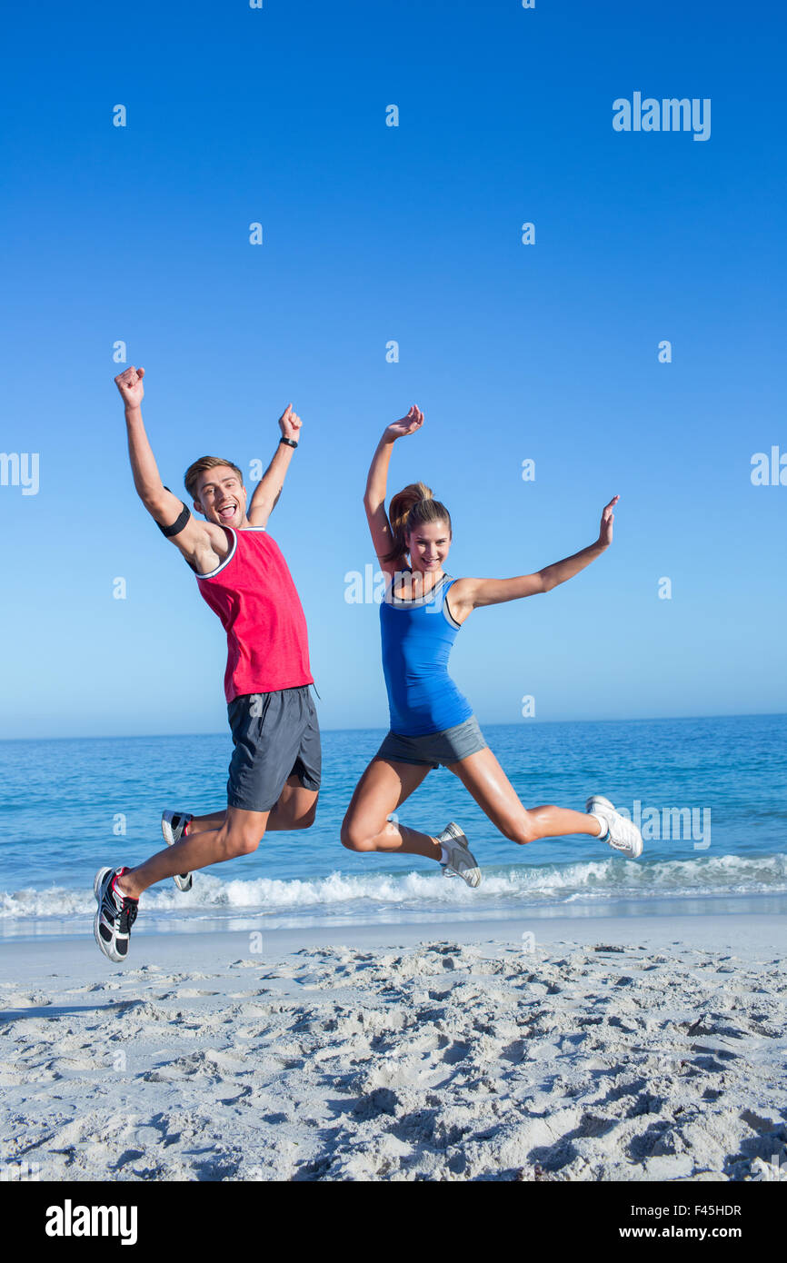 Happy couple jumping together Stock Photo - Alamy