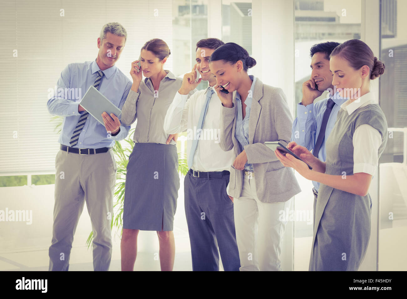 Business people using their phone Stock Photo - Alamy