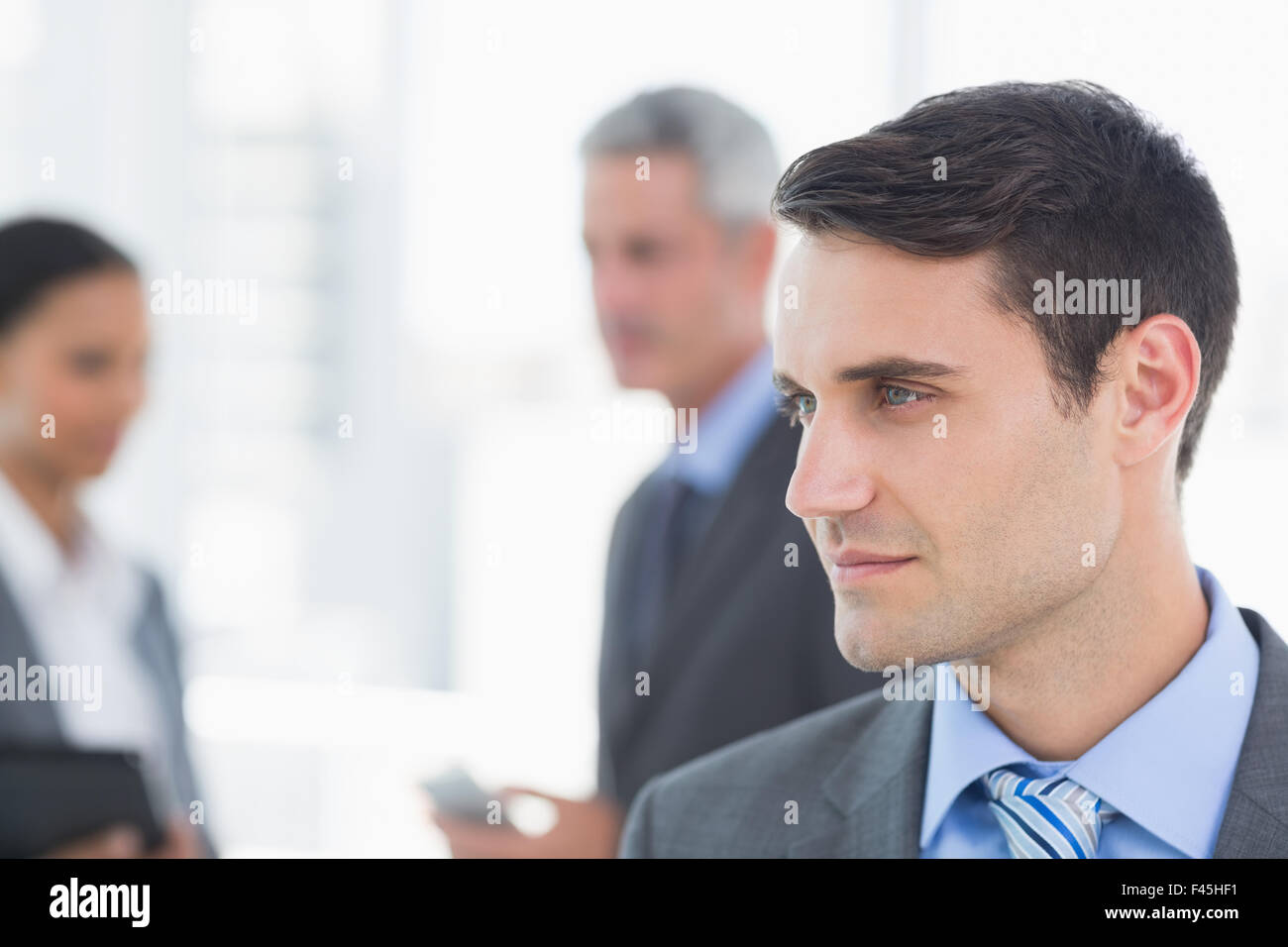 Businessman standing colleagues behind hi-res stock photography and ...