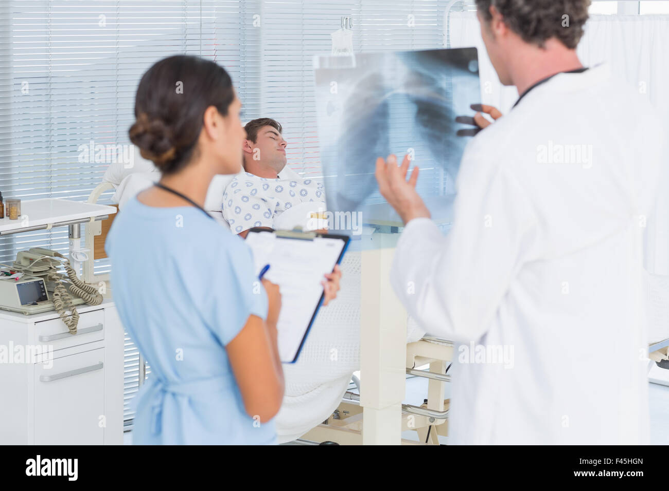 Doctors checking patients xray Stock Photo - Alamy