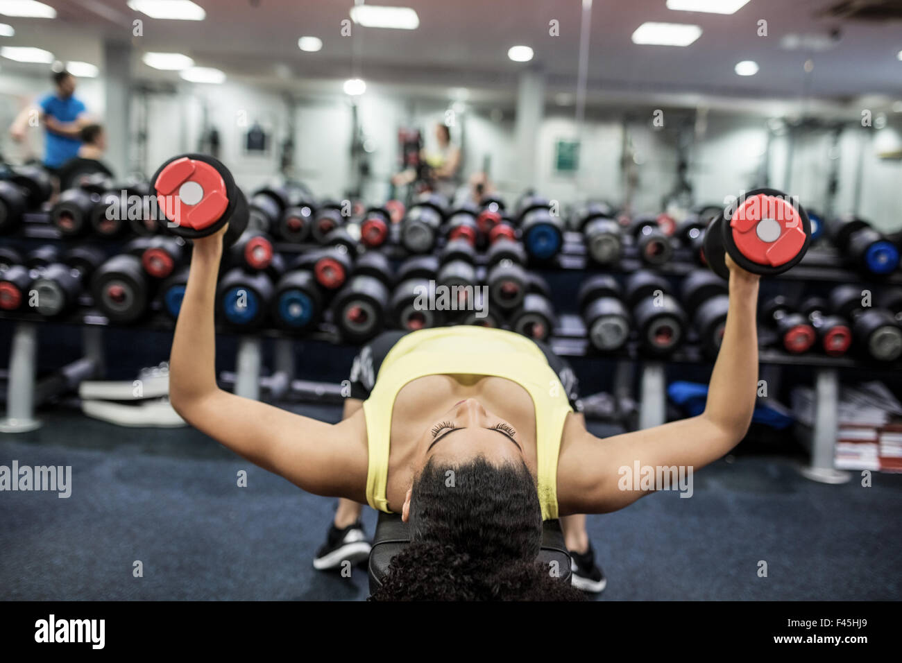 Woman working out lifting weights hi-res stock photography and images ...