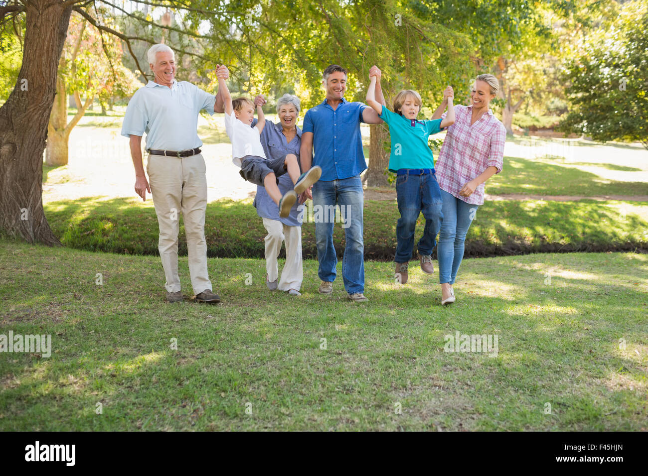 Happy family playing together in the park Stock Photo - Alamy