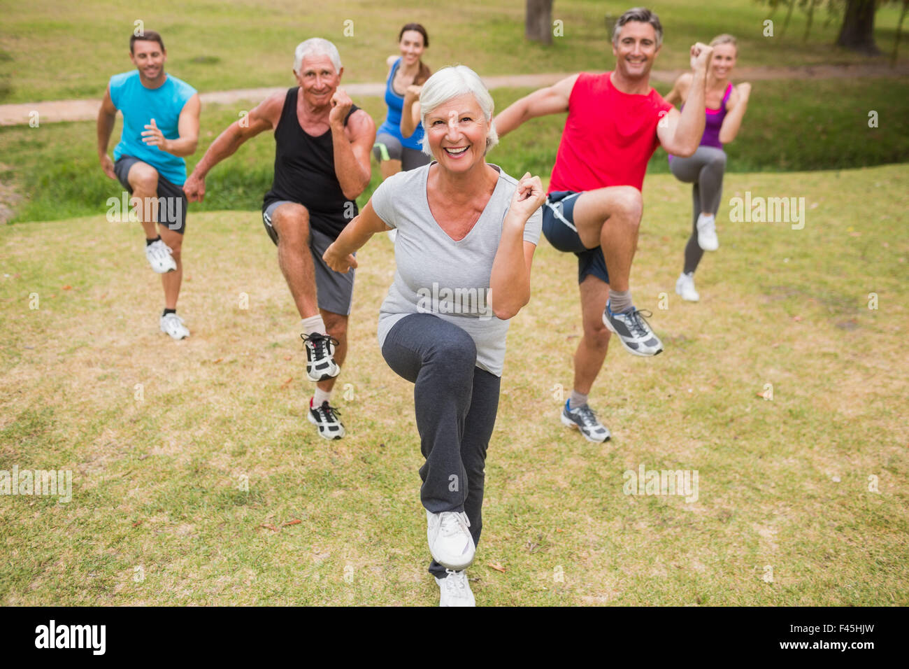 Happy athletic group training Stock Photo - Alamy