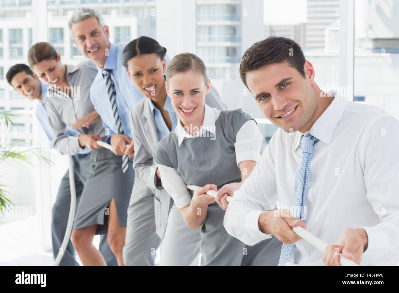 Business people pulling rope Stock Photo - Alamy