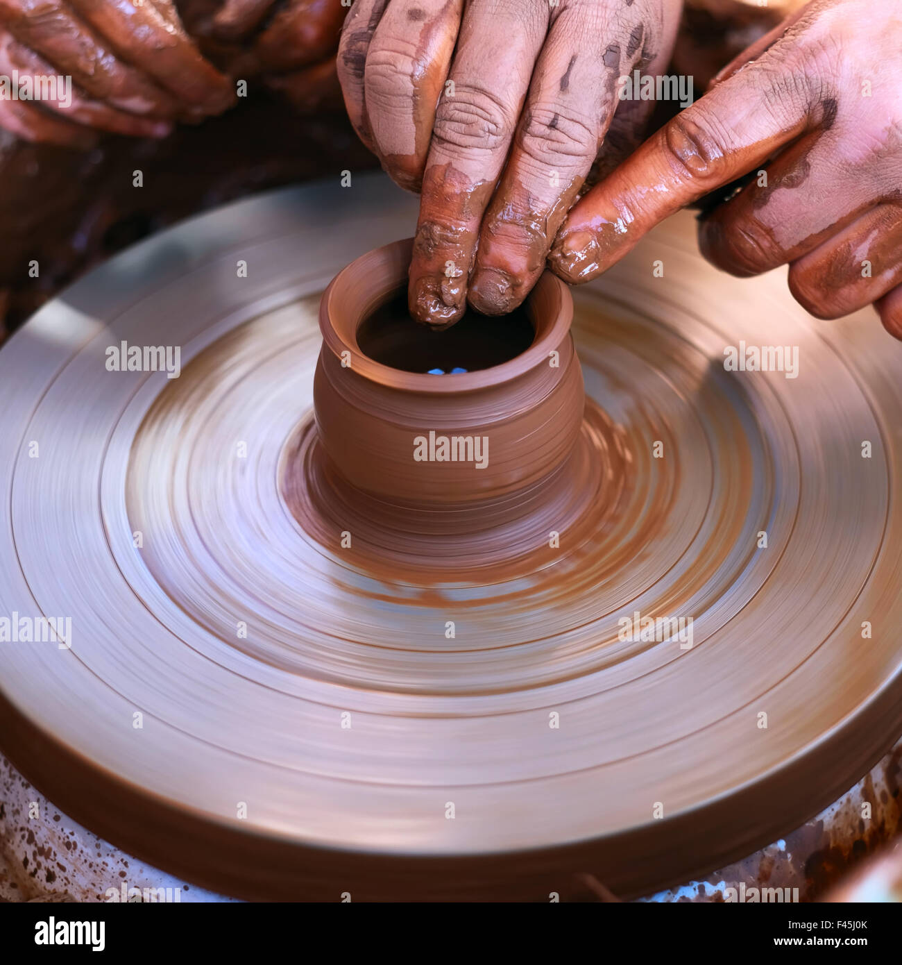 Hands working on pottery wheel Stock Photo - Alamy