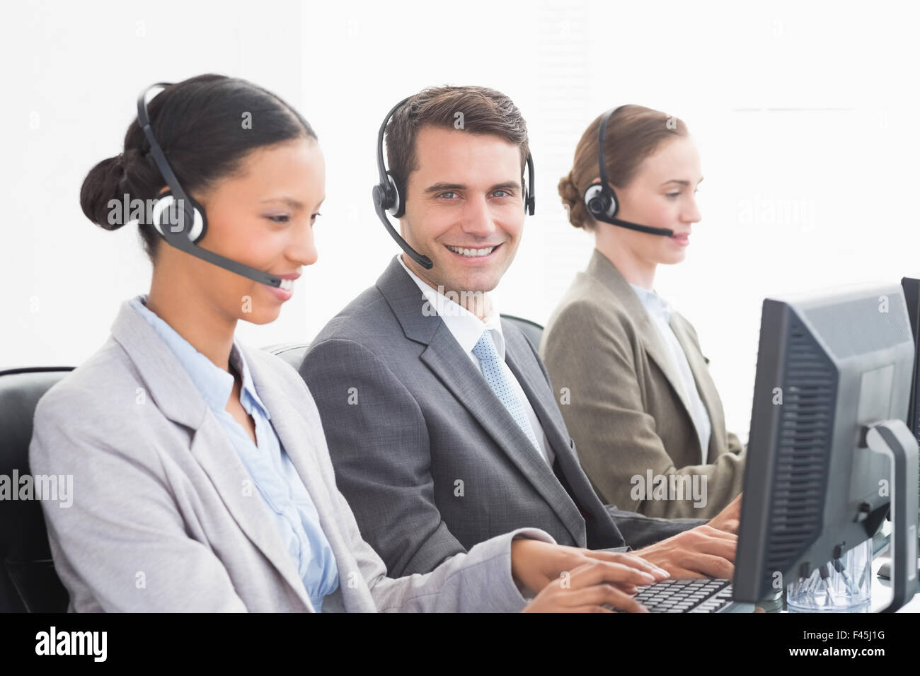 Business people with headsets using computers Stock Photo - Alamy