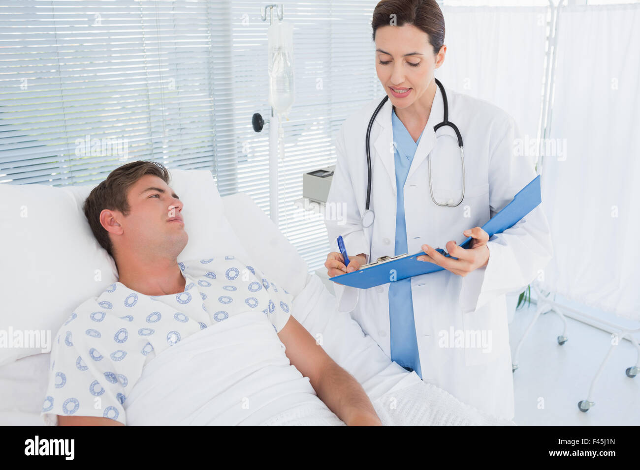 Doctor taking care of patient Stock Photo - Alamy