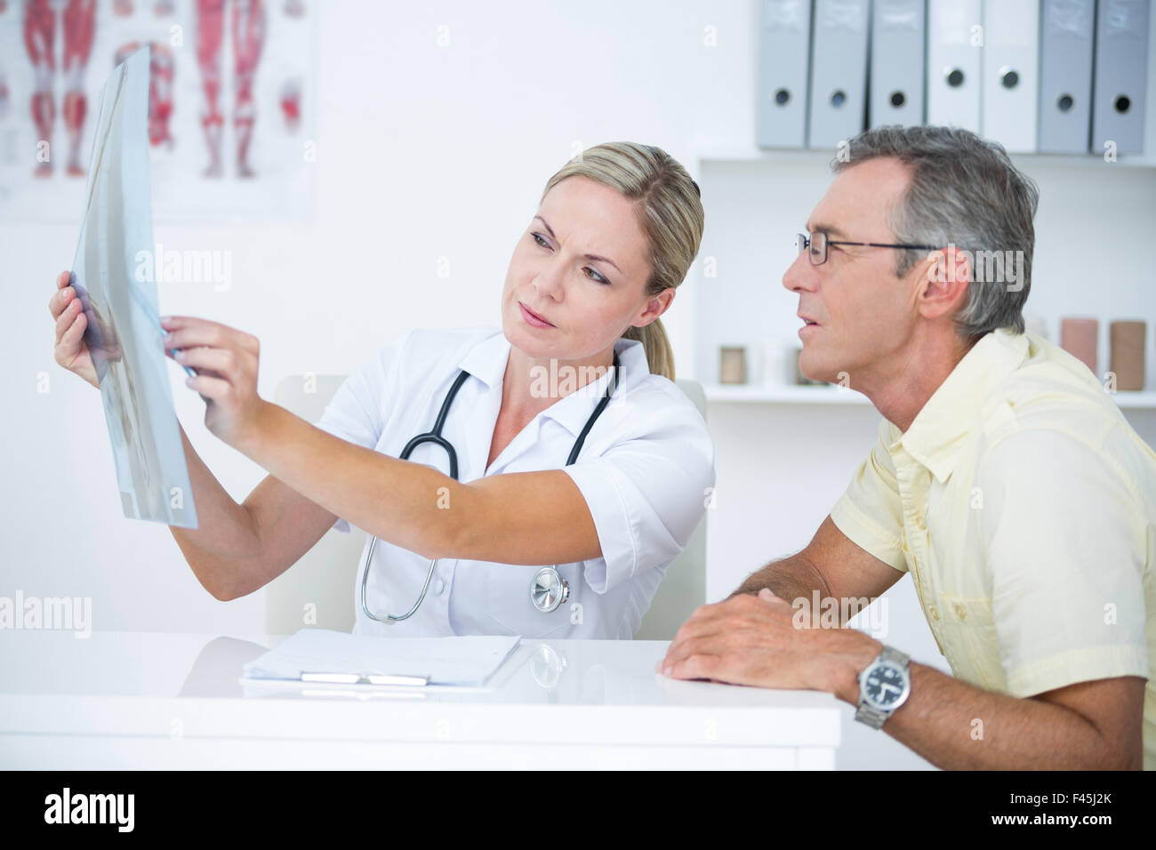 Doctor showing X rays to her patient Stock Photo - Alamy