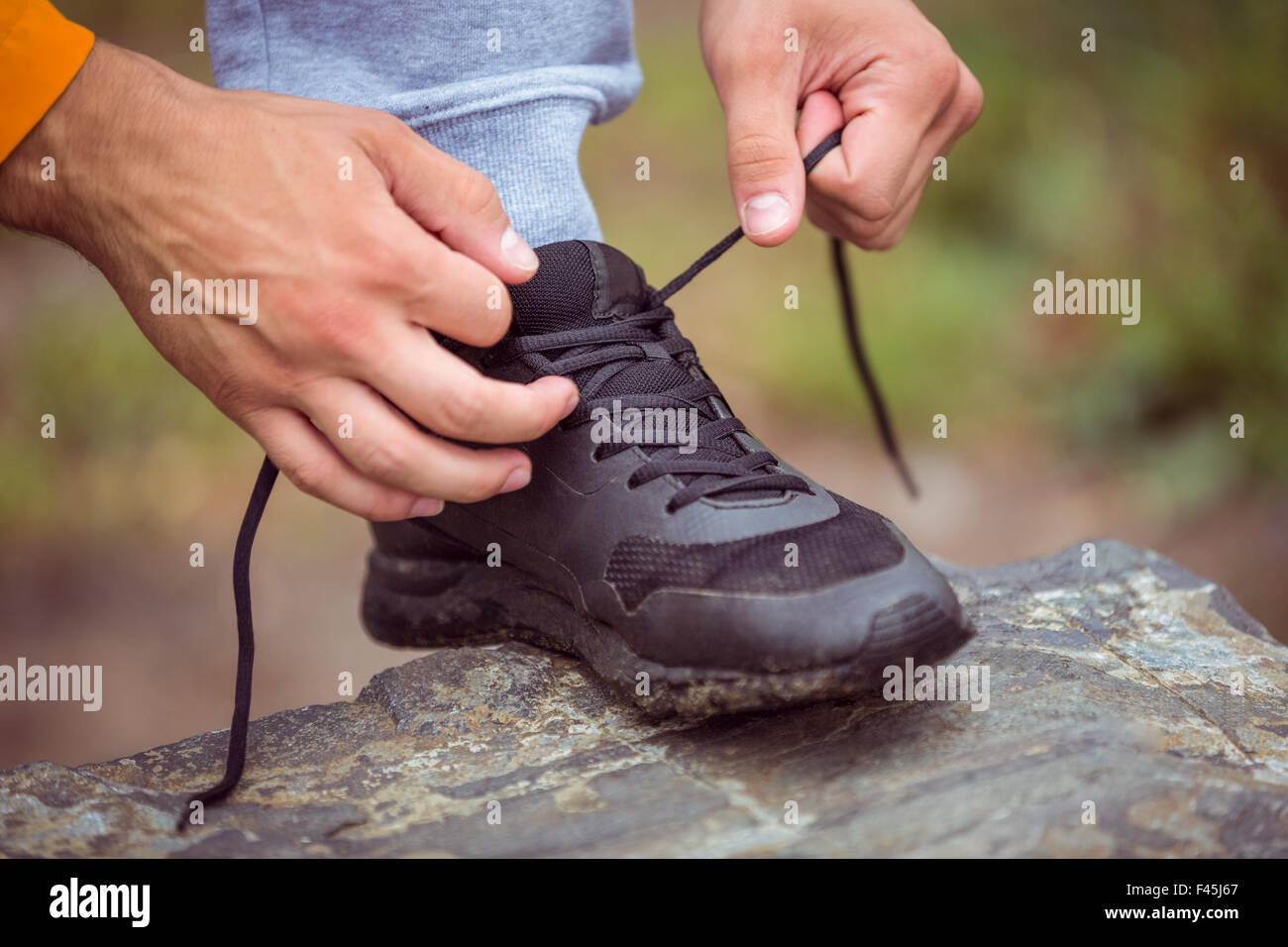 Man tying his shoe lace Stock Photo - Alamy