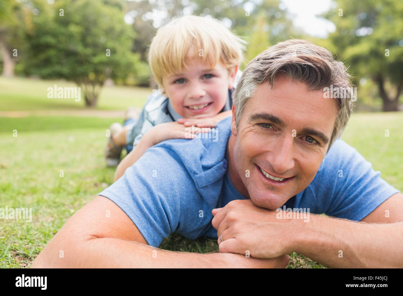 Happy father and his son smiling at camera Stock Photo - Alamy