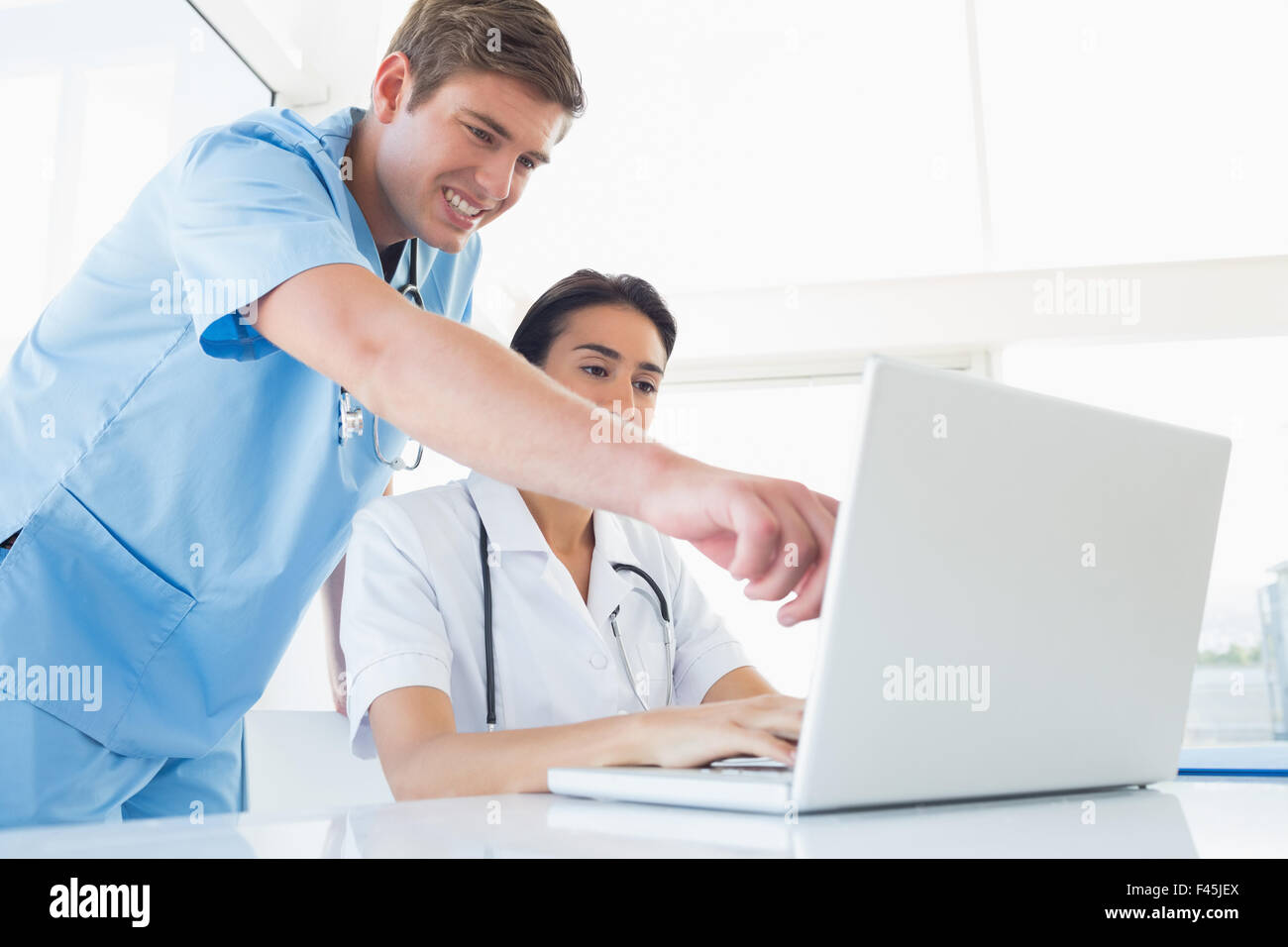 Doctors working with laptop computer Stock Photo - Alamy