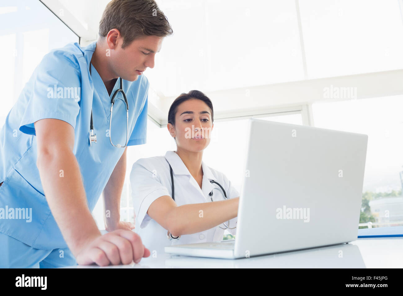 Doctors working on laptop computer Stock Photo - Alamy