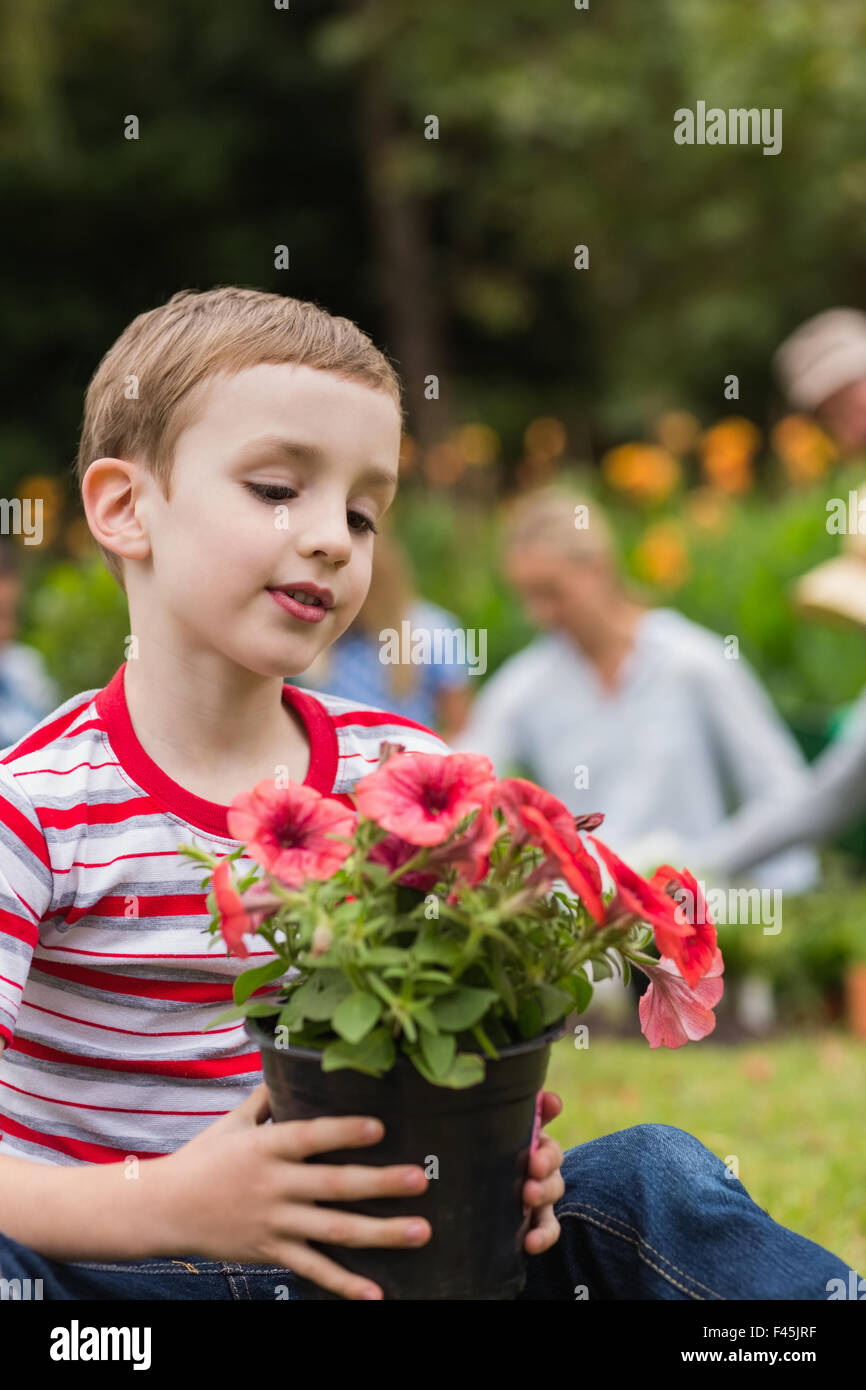 Young boy sitting with flower pot Stock Photo - Alamy