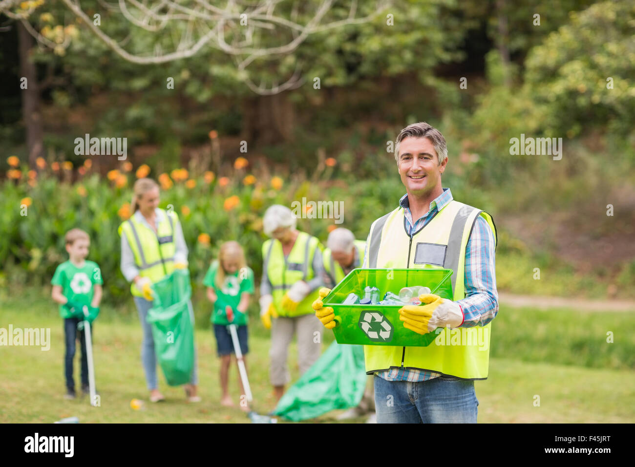 Happy family collecting rubbish Stock Photo - Alamy