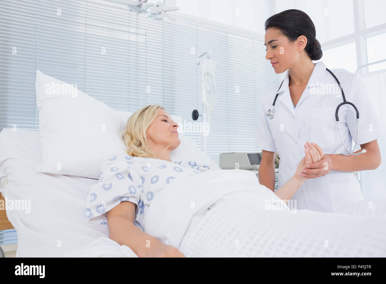 Doctor taking care of patient Stock Photo - Alamy