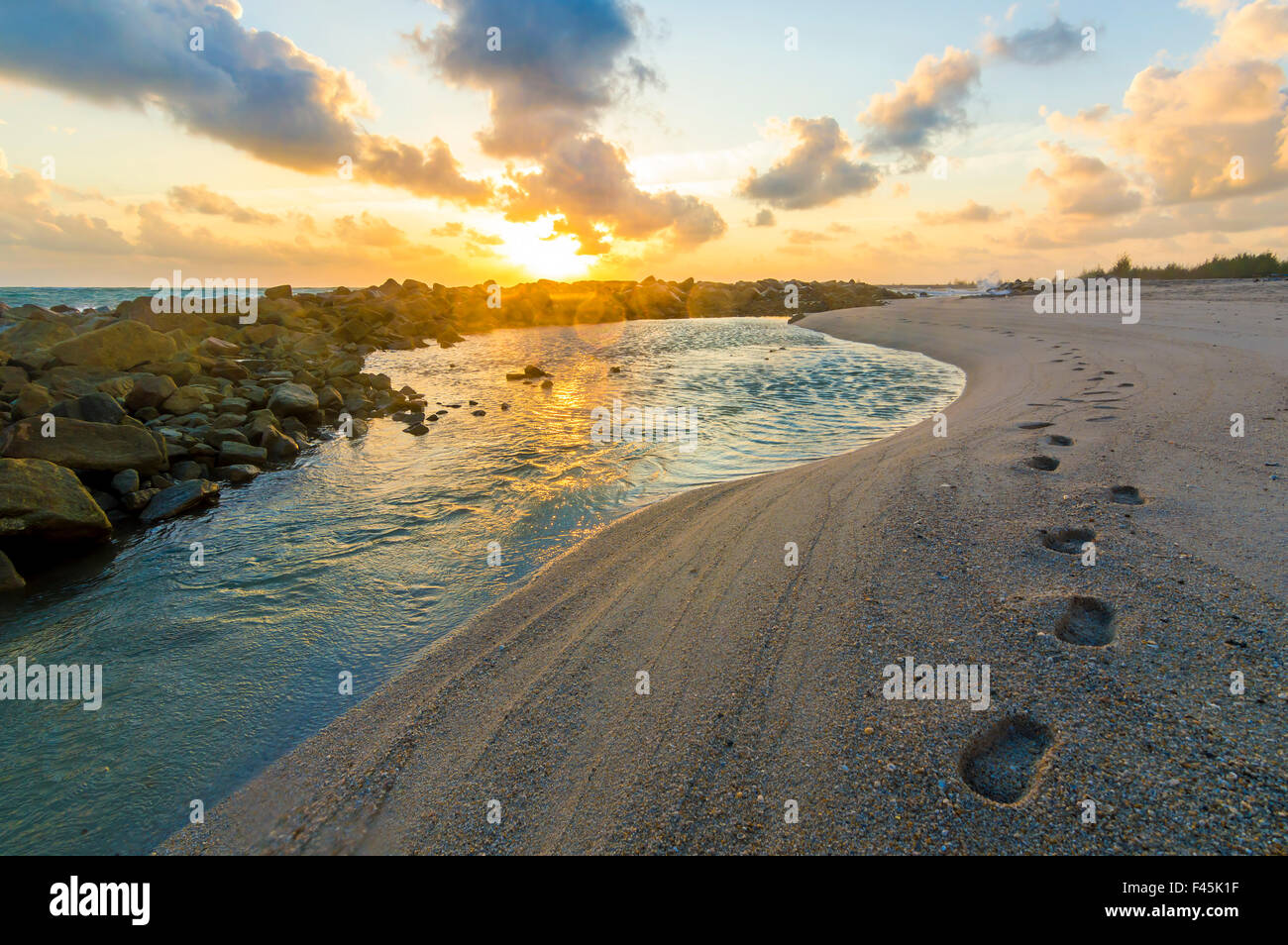 Foot mark on sand with beautiful sunrise background Stock Photo - Alamy