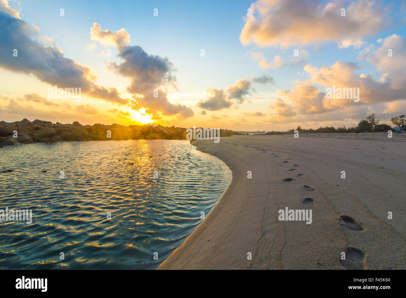 Foot mark on sand with beautiful sunrise background Stock Photo - Alamy
