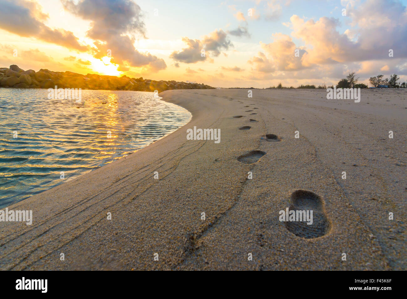 Foot mark on sand with beautiful sunrise background Stock Photo - Alamy