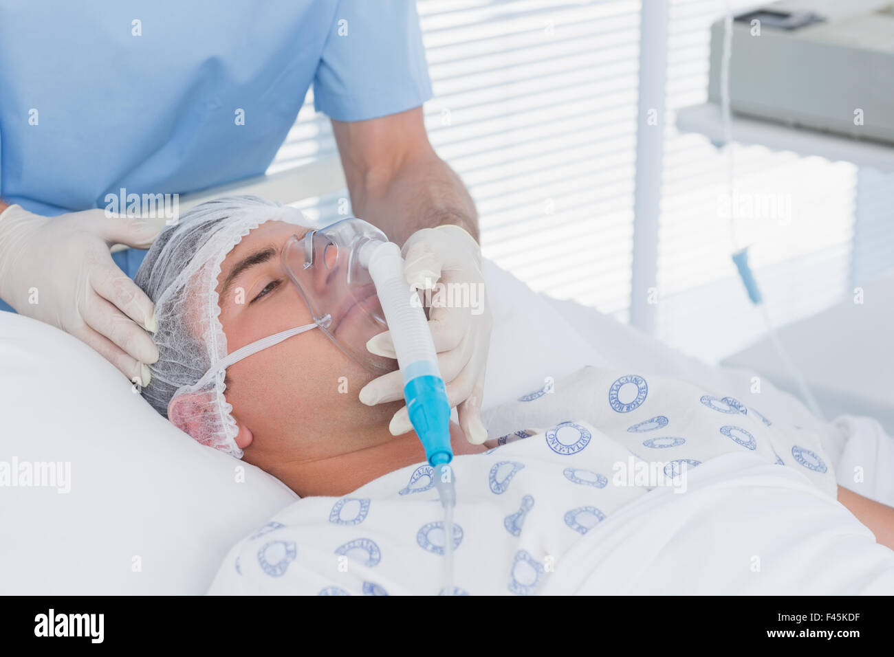 Doctor holding patients oxygen mask Stock Photo - Alamy