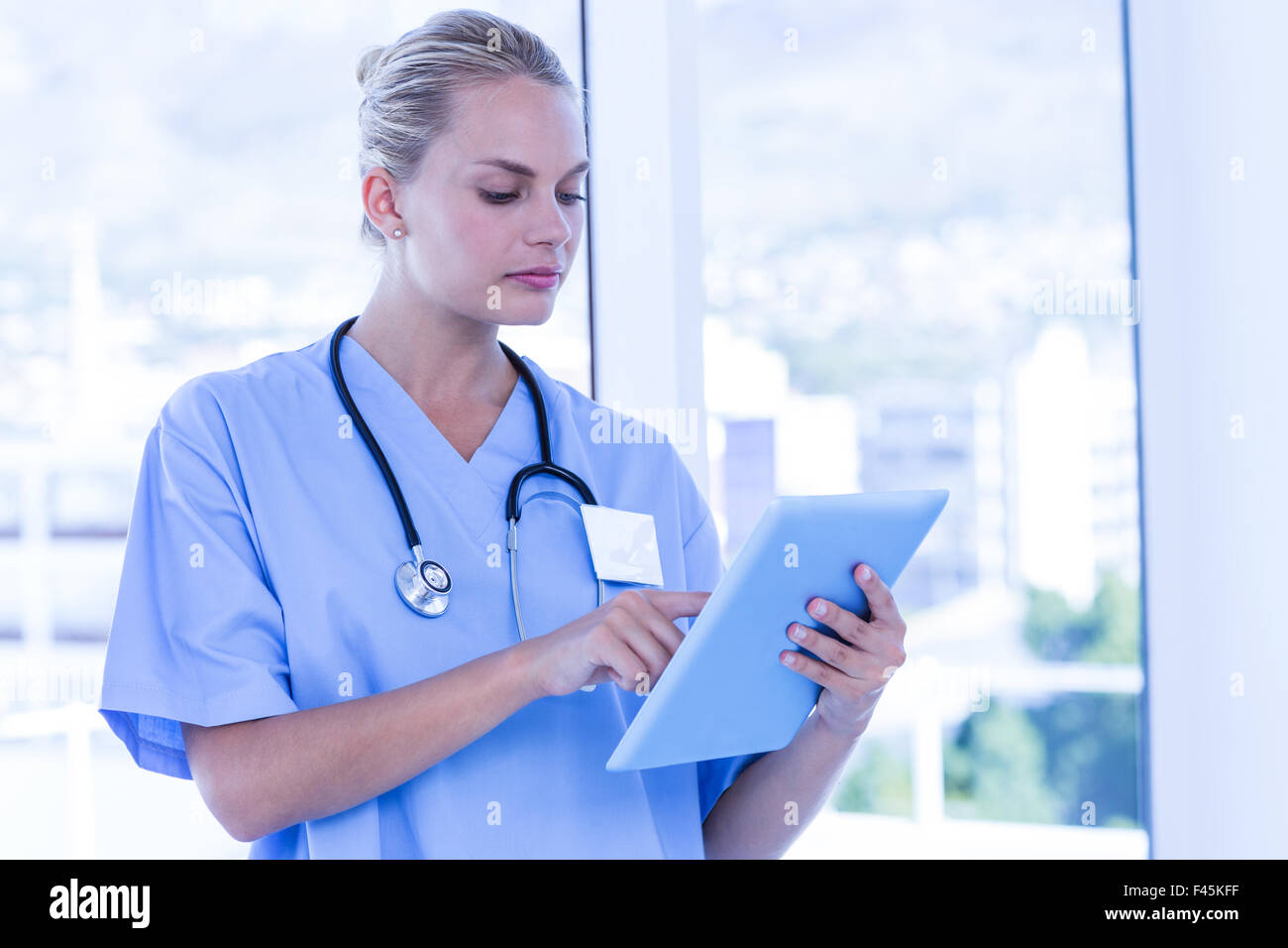 Nurse using her tablet pc Stock Photo - Alamy