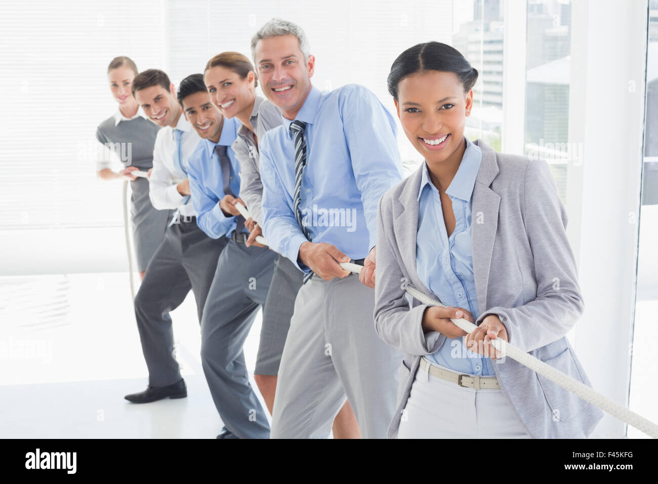 Business people pulling rope Stock Photo - Alamy