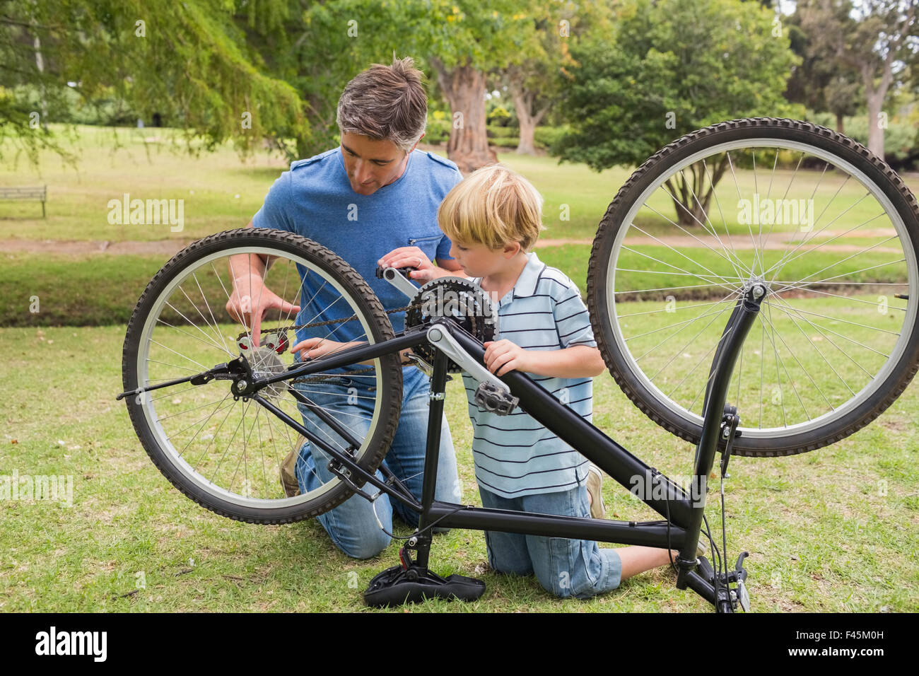 Father and his son fixing a bike Stock Photo - Alamy