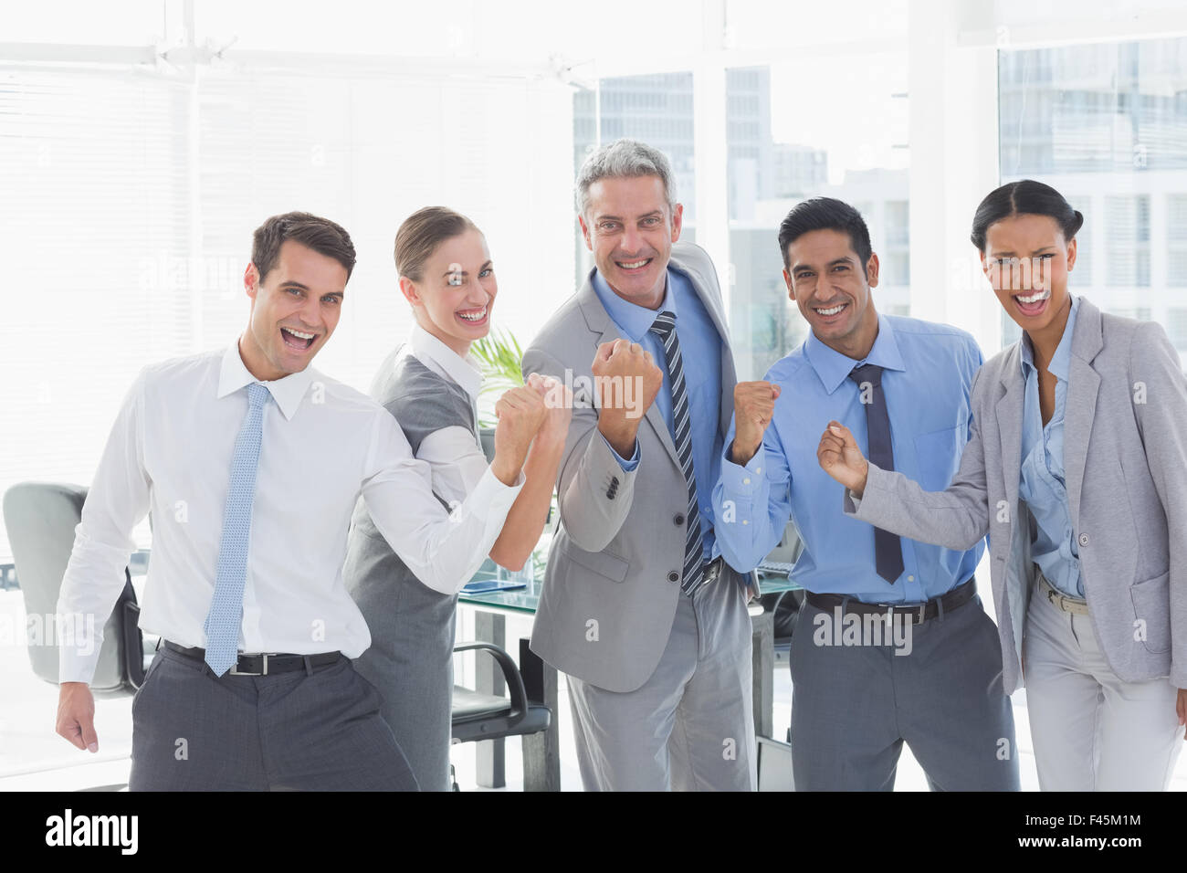 Business people cheering in office Stock Photo - Alamy