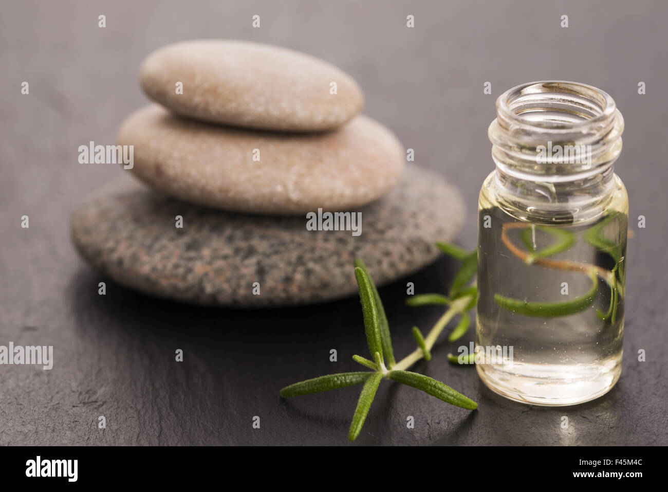 Essential oil with rosemary and fresh green leaves Stock Photo - Alamy