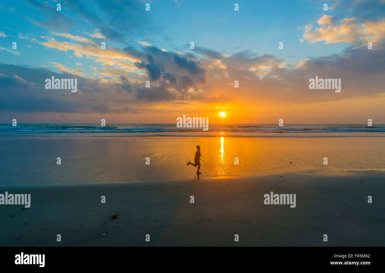Sunrise with children running foreground Stock Photo - Alamy