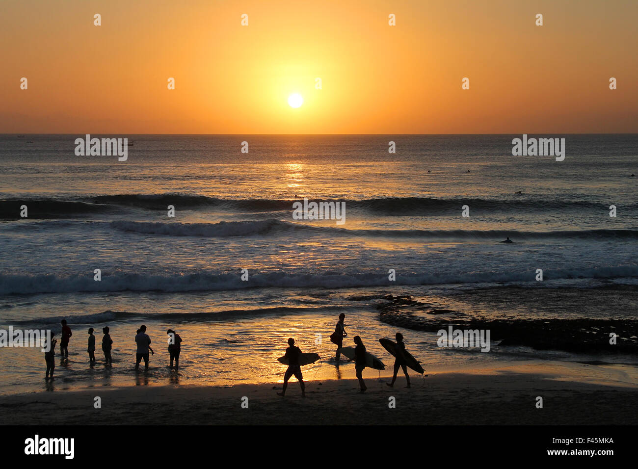 Surfers on sunset Stock Photo - Alamy